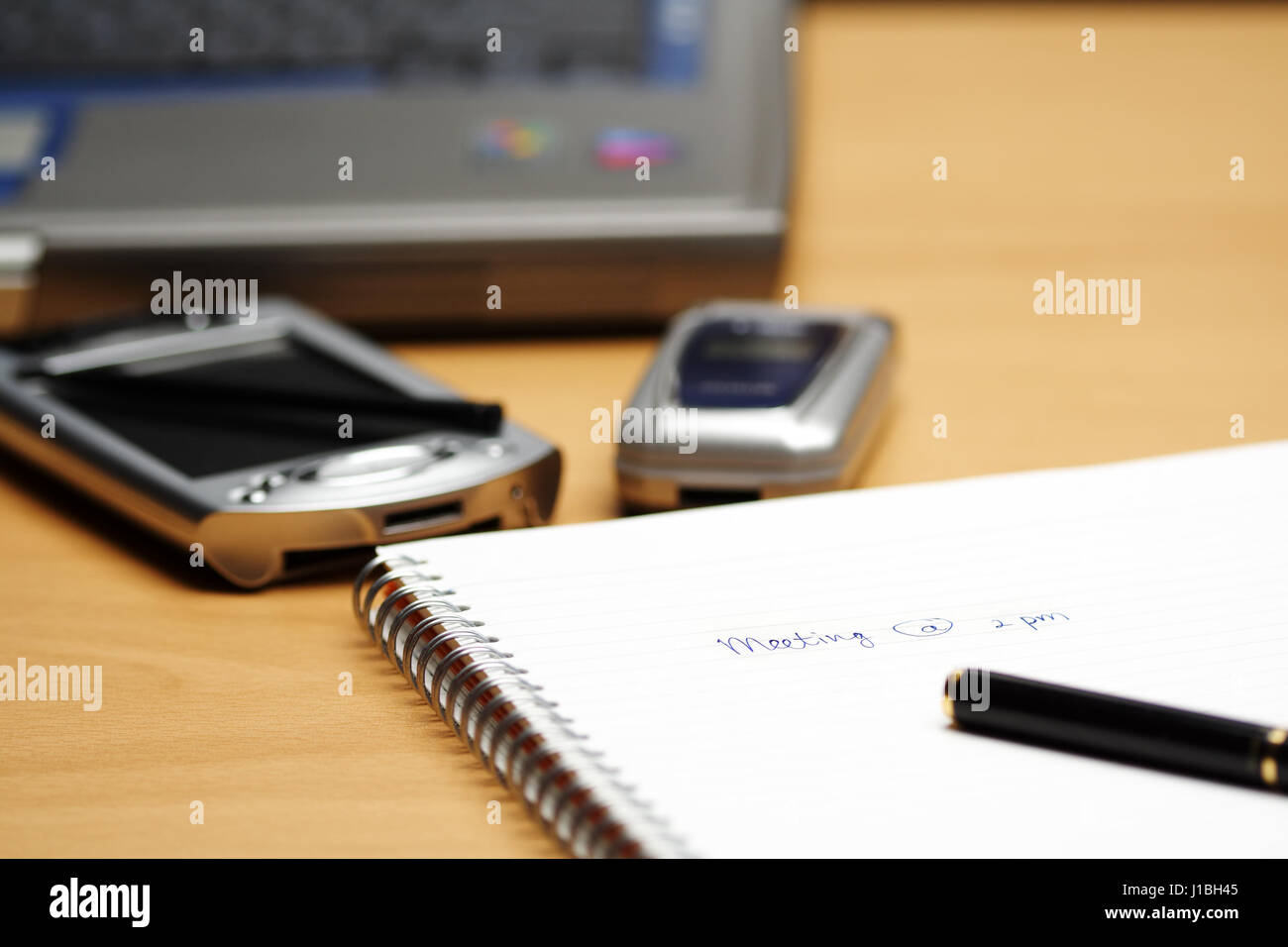 A meeting reminder written in a notepad Stock Photo - Alamy
