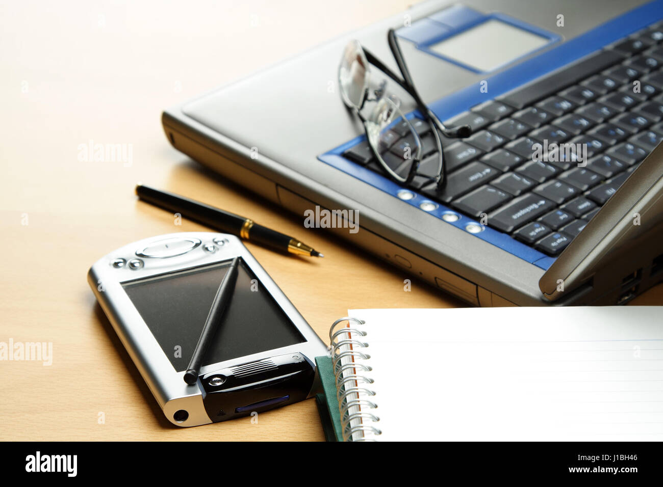 A PDA, notebook and laptop in a typical business environment setting Stock Photo - Alamy