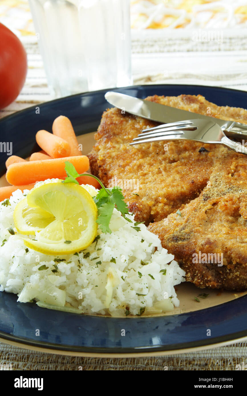 A baked pork chop with rice and carrot Stock Photo - Alamy
