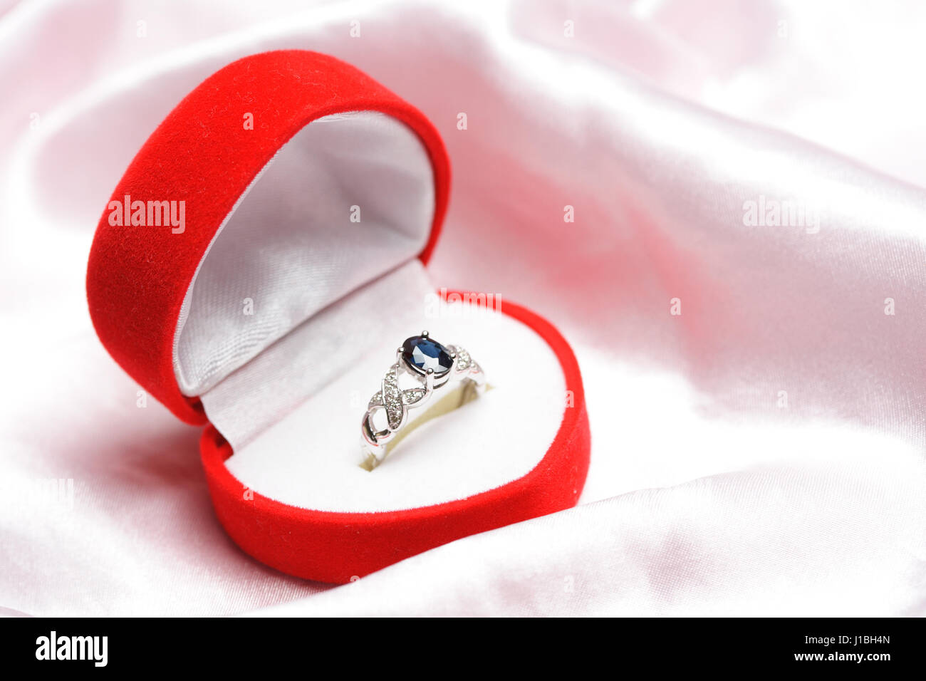 A diamond sapphire ring in a jewelry box Stock Photo - Alamy