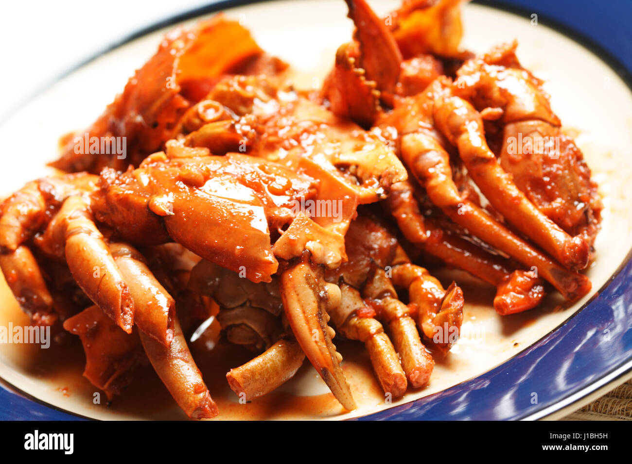 Delicious crabs cooked with spicy sweet and sour sauce Stock Photo - Alamy