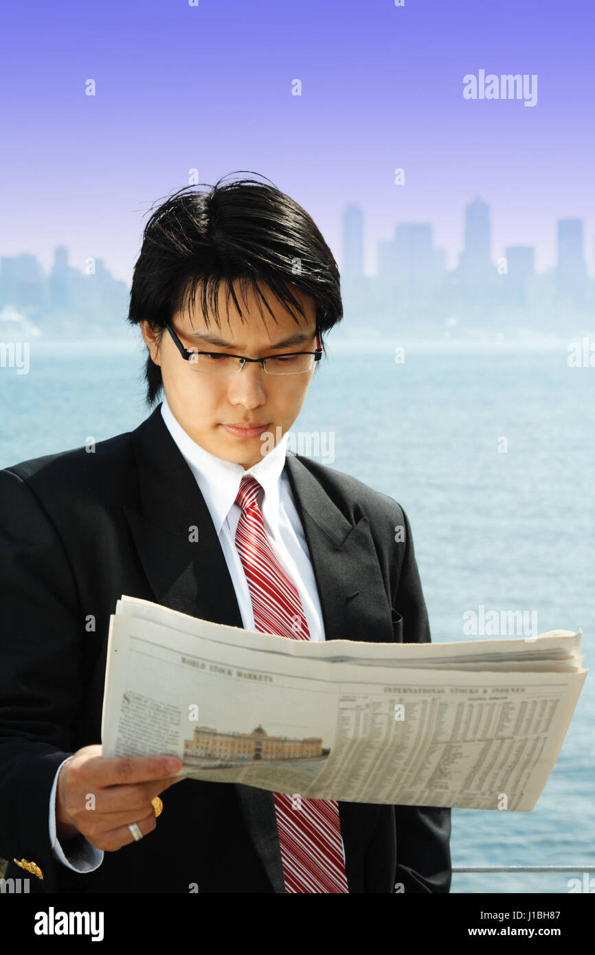 A businessman reading a financial newspaper outdoor Stock Photo - Alamy