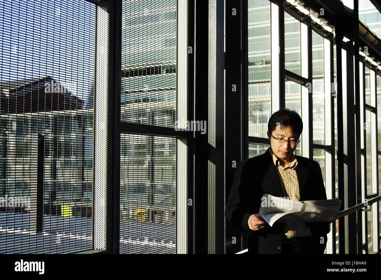 A businessman reading financial newspaper on a train station Stock ...