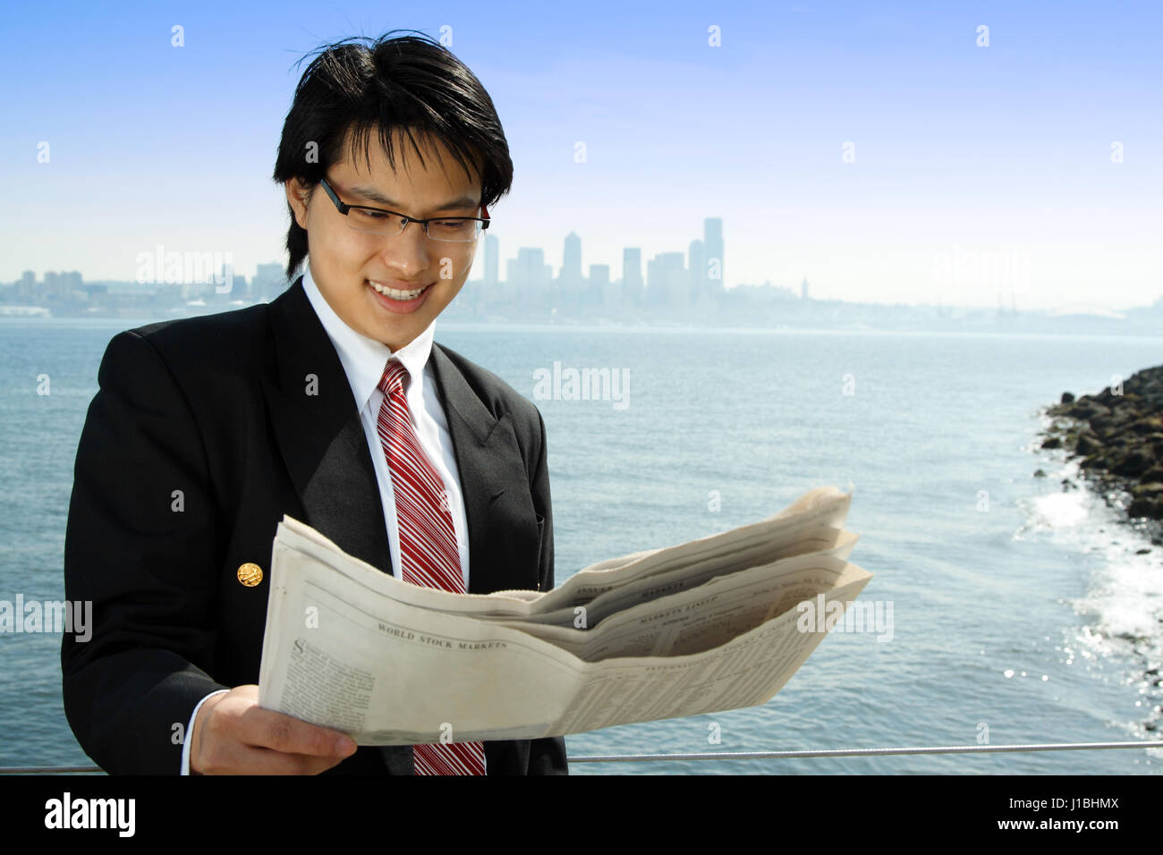A businessman reading a financial newspaper on the beach Stock Photo ...
