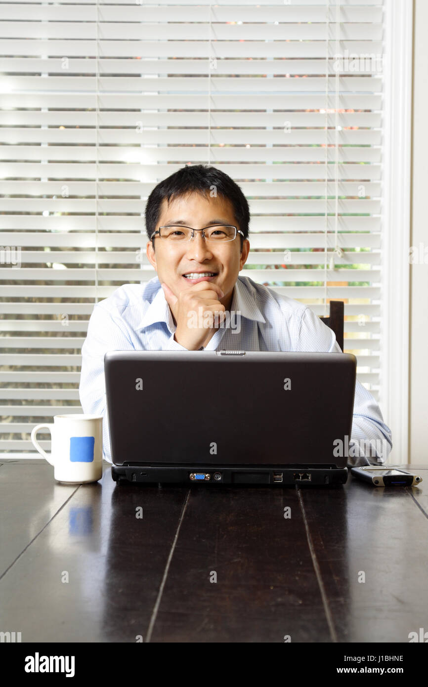 An asian businessman working on his laptop Stock Photo - Alamy