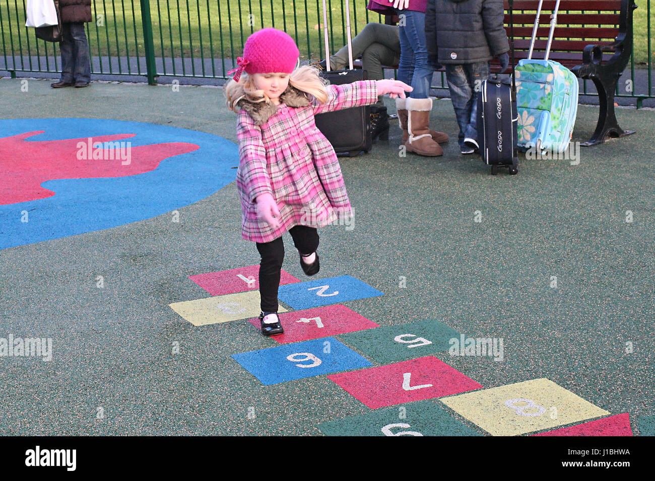 Little girl, child playing hopscotch in the playground in Stephen's ...