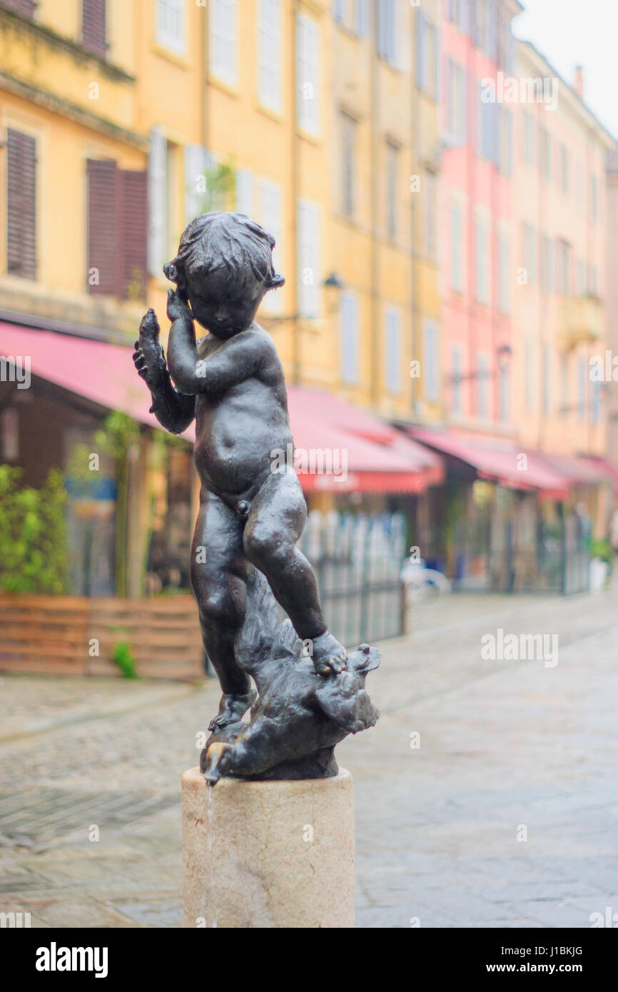 Statue and street scene in the historic center of Modena, Emilia ...