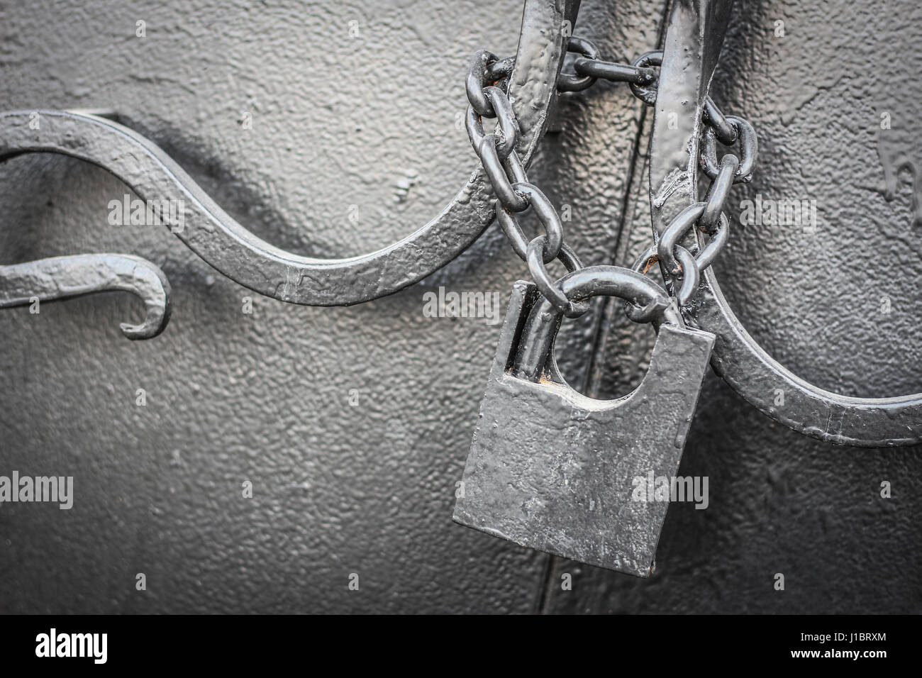 Old lock on a chain on an iron door Stock Photo - Alamy