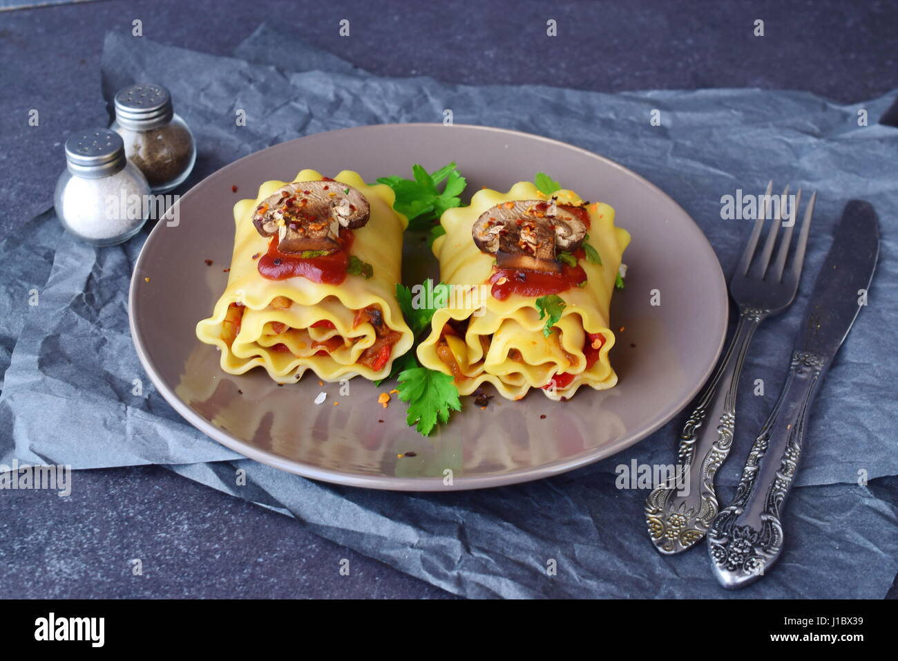 Pasta rolls with vegetables: paprika, onion, olives, mushrooms, tomato ...