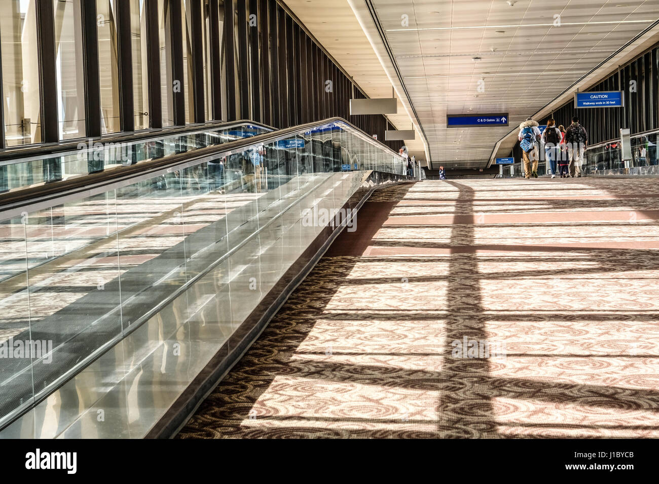 A Horizontal View of a Sun Lit International Airport Corridor with ...