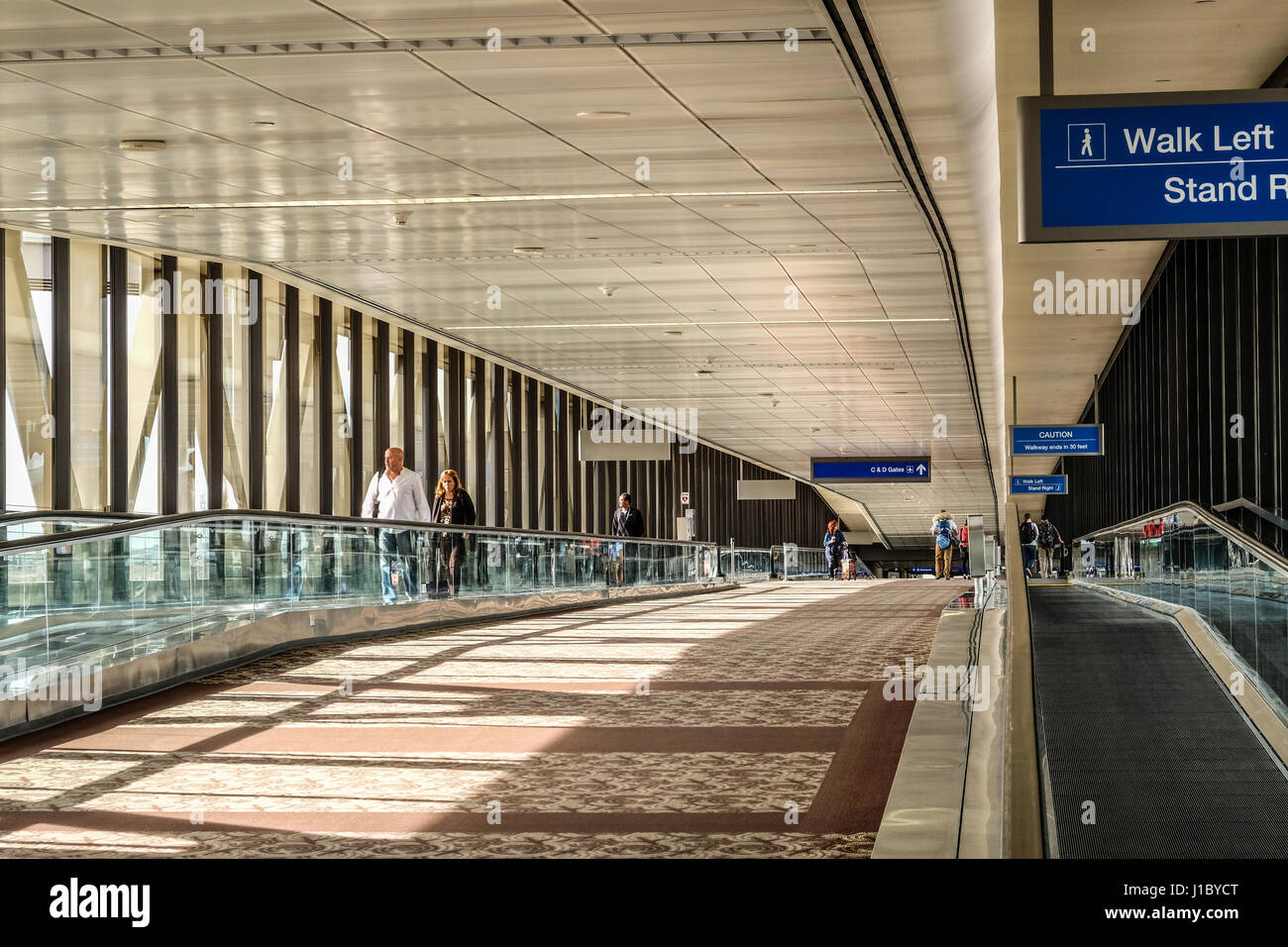 A Horizontal View of a Sun Lit International Airport Corridor with ...