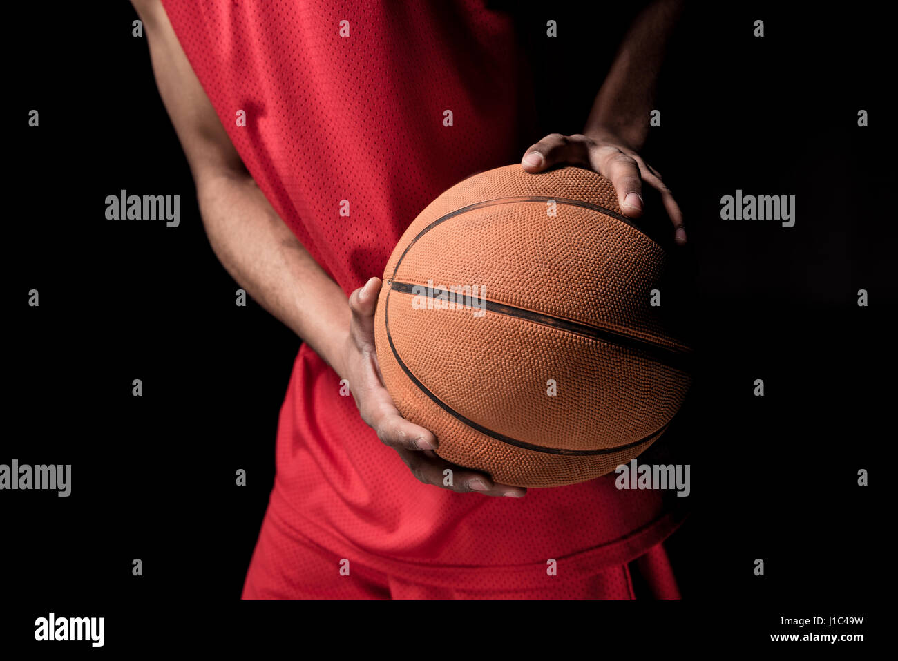 Close-up partial view of young sporty man holding basketball ball Stock ...