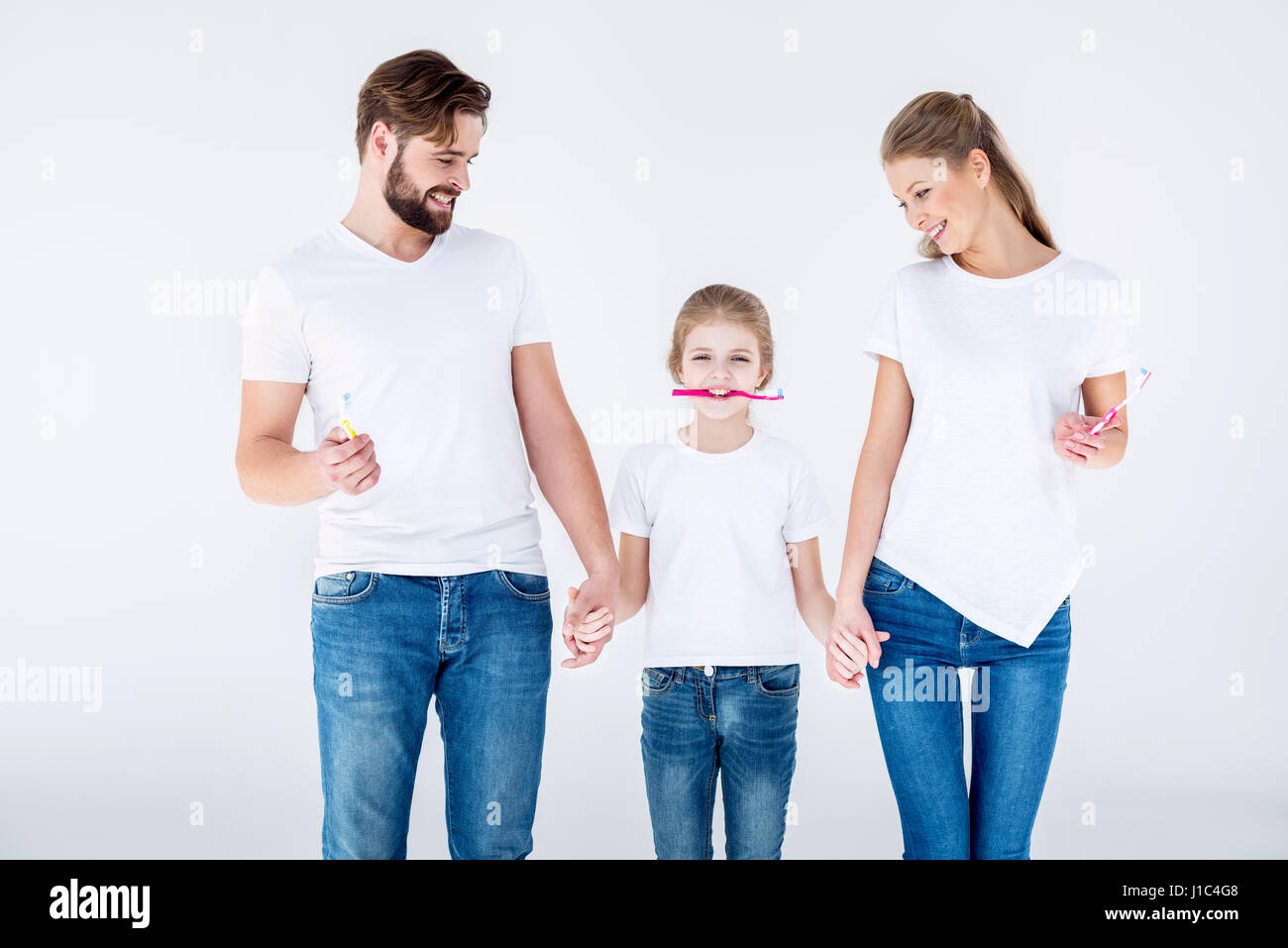 Parents holding daughter white shirts hi-res stock photography and images - Alamy