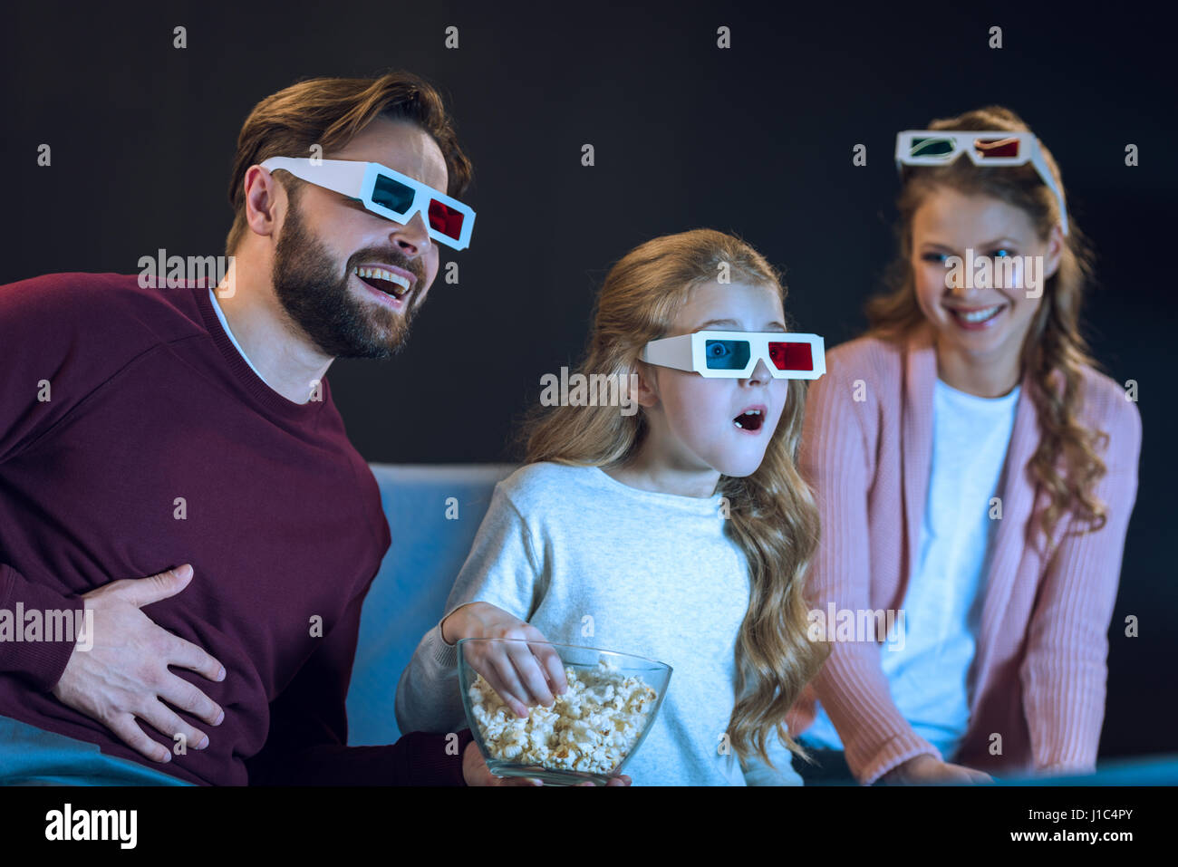Laughing caucasian man eating popcorn hi-res stock photography and ...