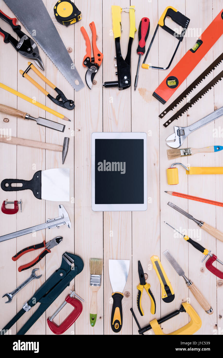 Top view of different tools with digital tablet on wooden tabletop ...