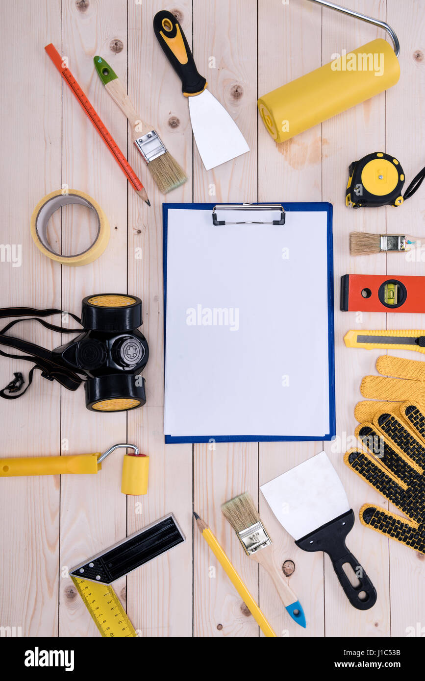 Top view of different tools with clipboard on wooden tabletop Stock ...