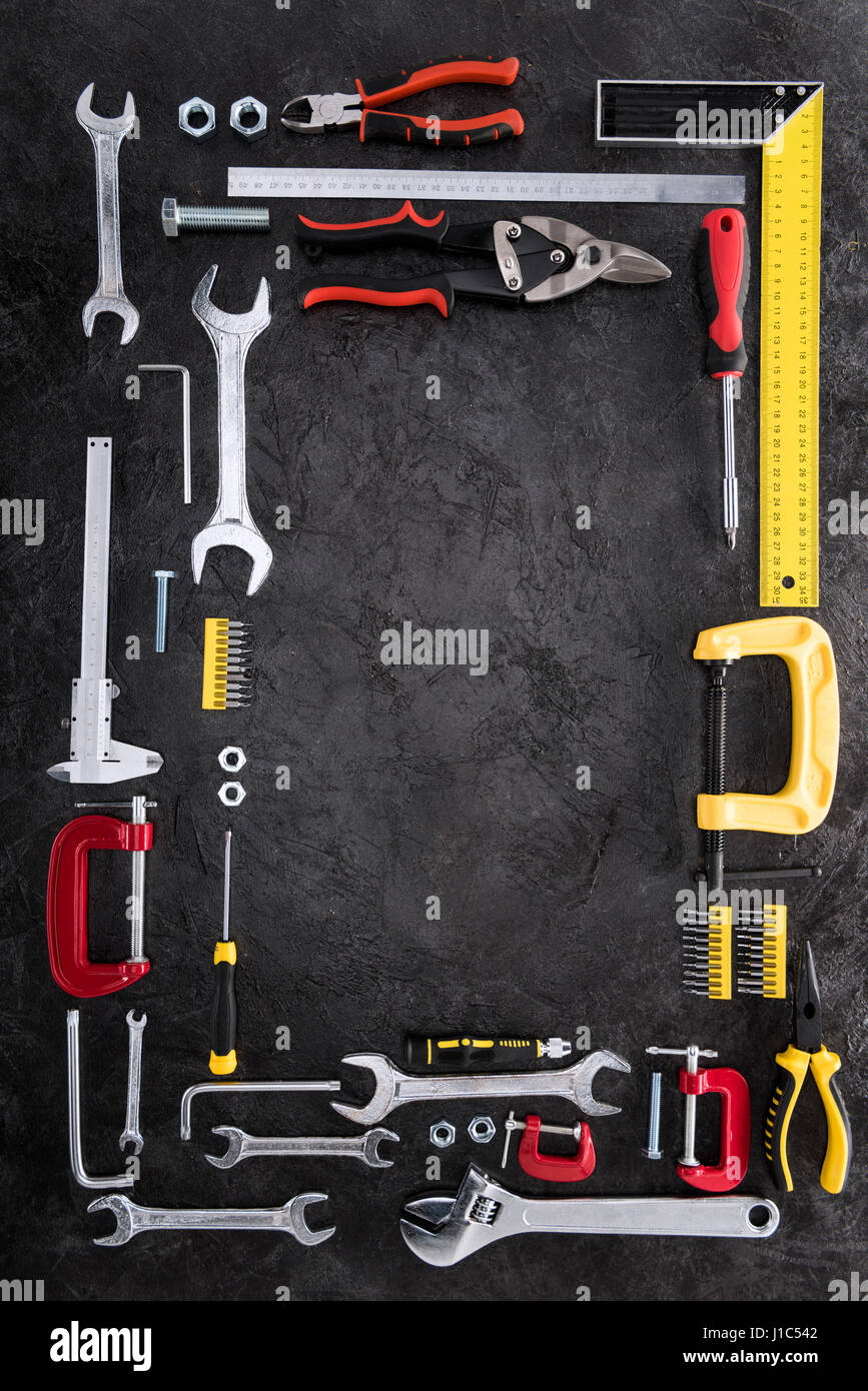 top view of set of various work tools on black Stock Photo - Alamy