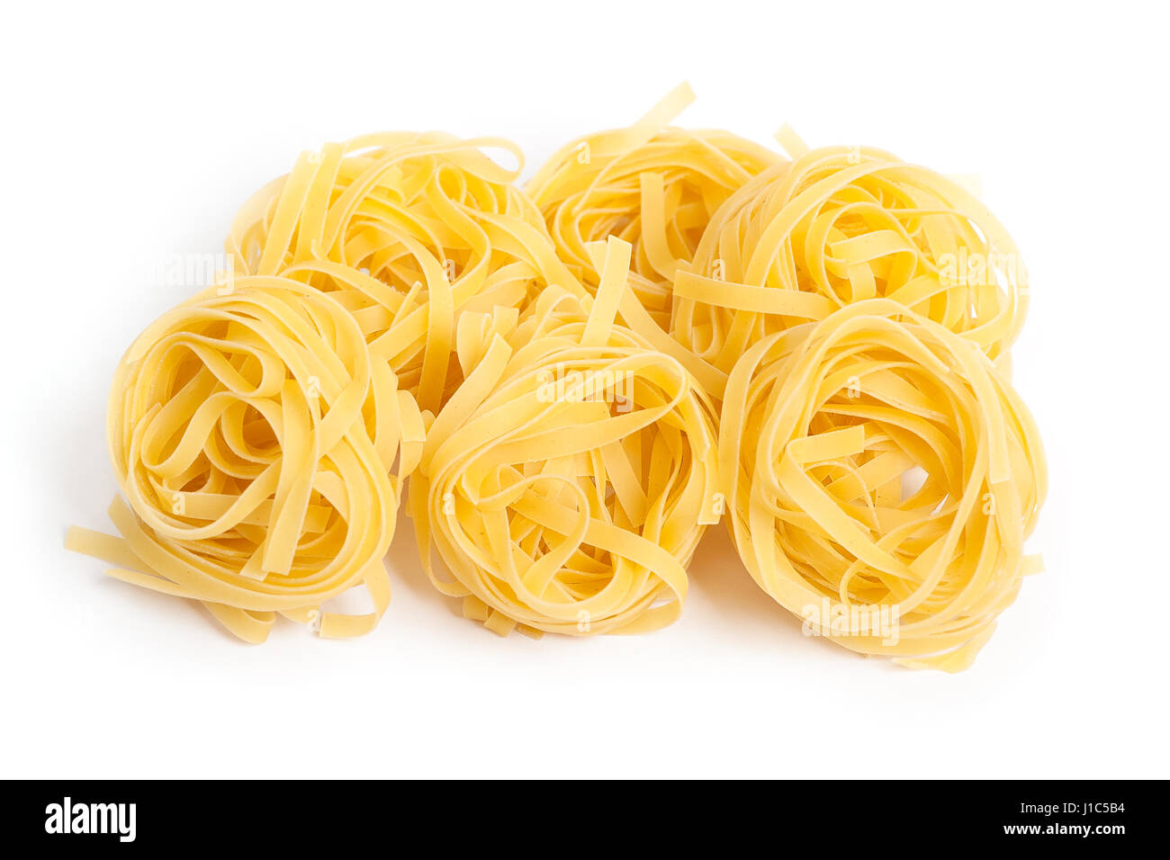 Pasta nests isolated on white background Stock Photo - Alamy