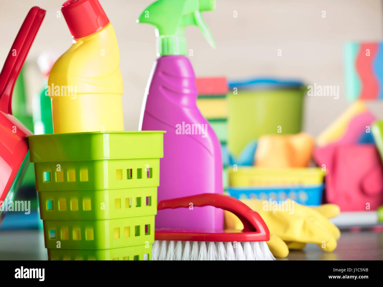 Spring cleanup theme. Variety of colorful house cleaning products on a ...