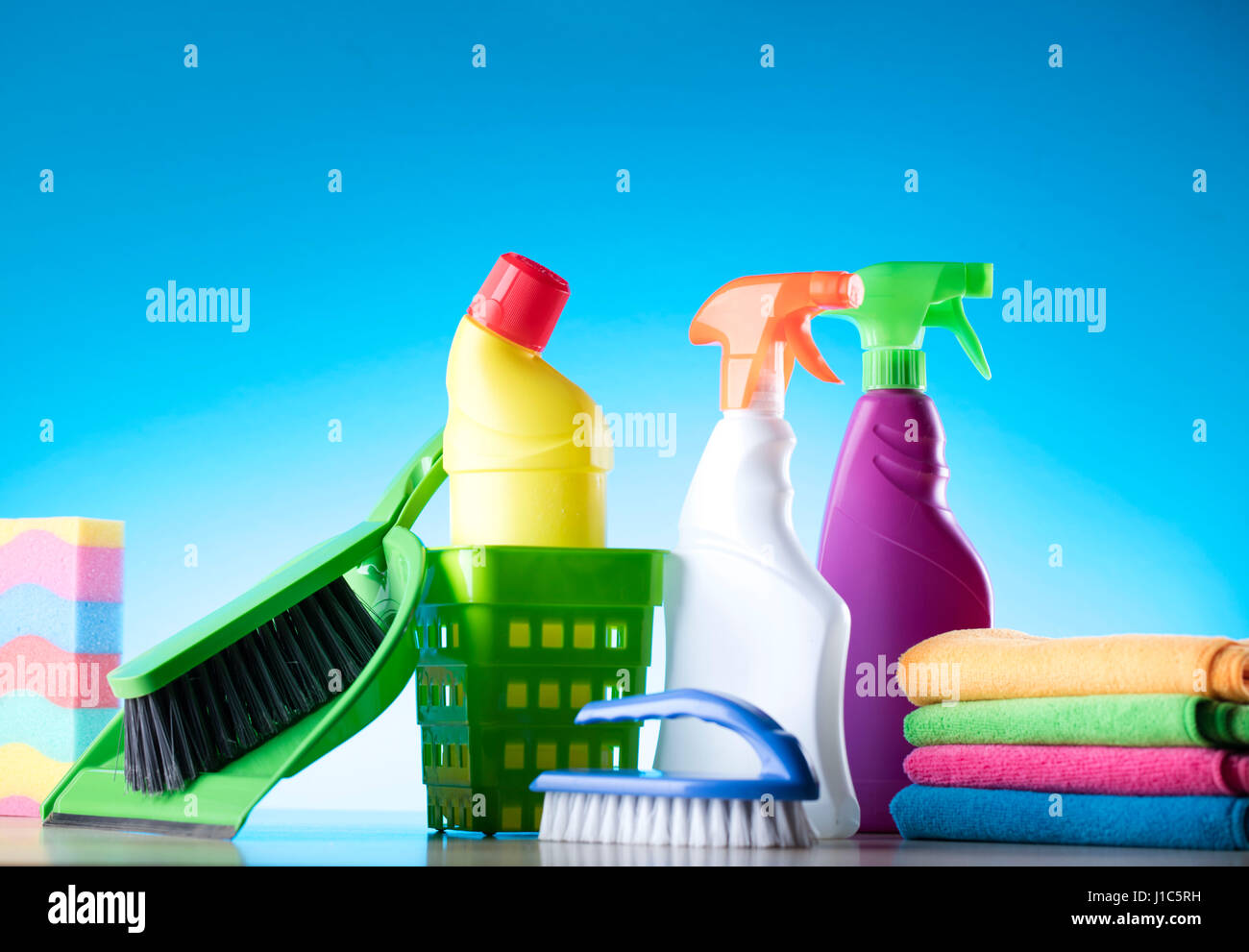 Spring cleanup theme. Variety of colorful house cleaning products on a ...