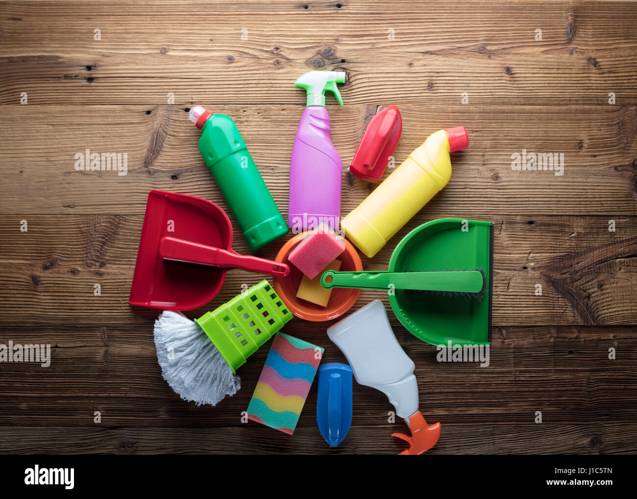 Spring cleanup theme. Variety of colorful house cleaning products on a ...