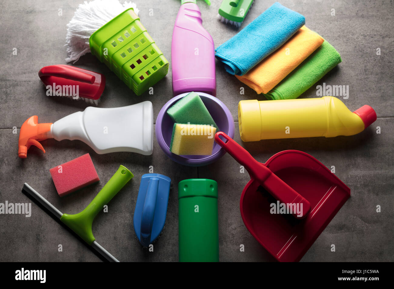 Spring cleanup theme. Variety of colorful house cleaning products on a ...