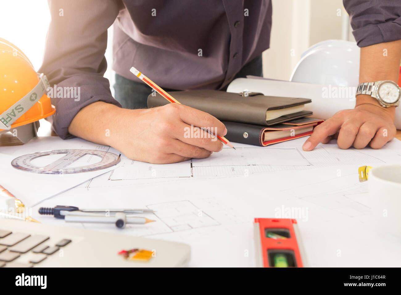 Architect concept, Architects working with blueprints in the office ...