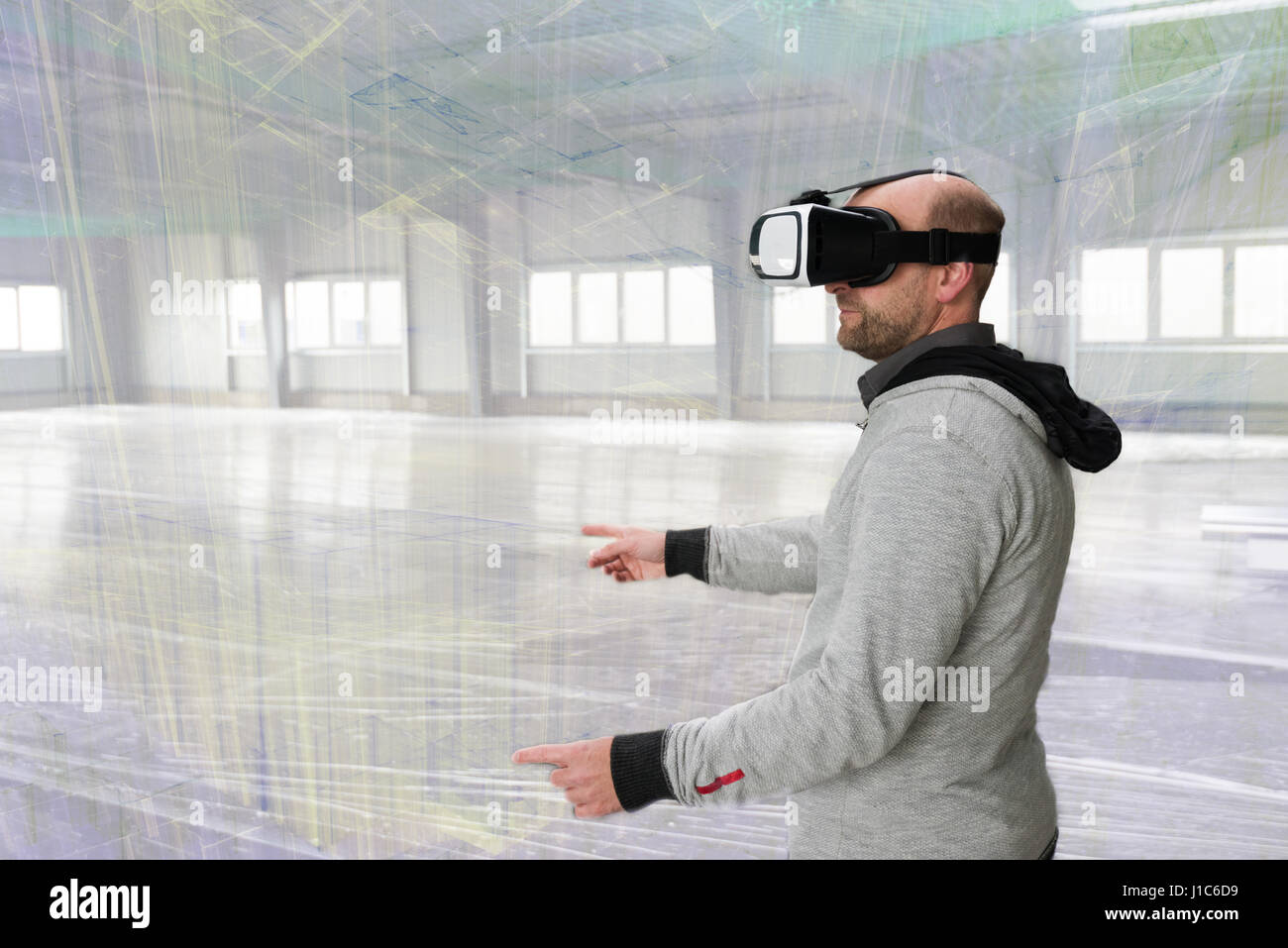 Architect with VR visor exploring industrial building environment Stock ...
