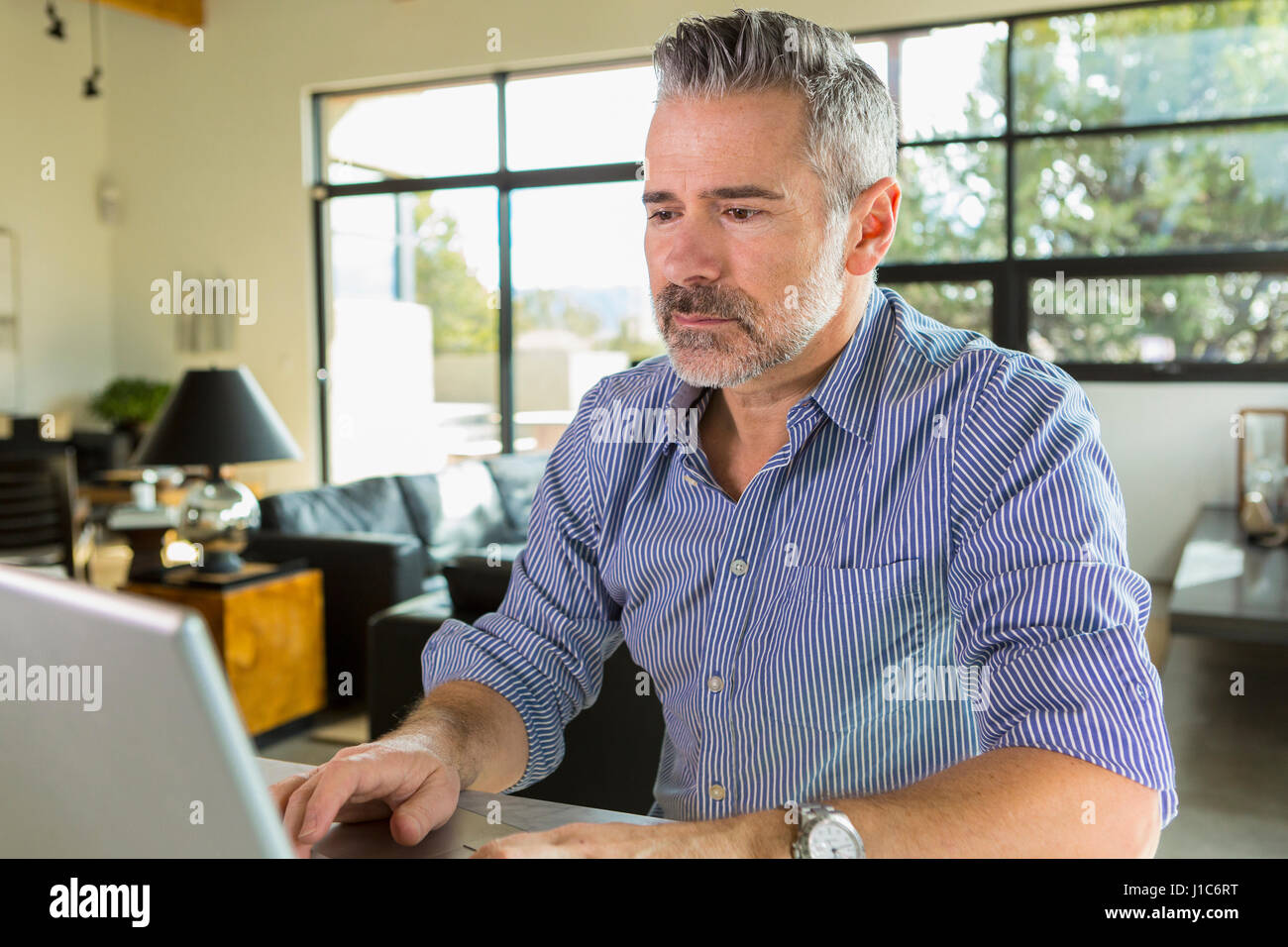 Man laptop indoors table hi-res stock photography and images - Alamy