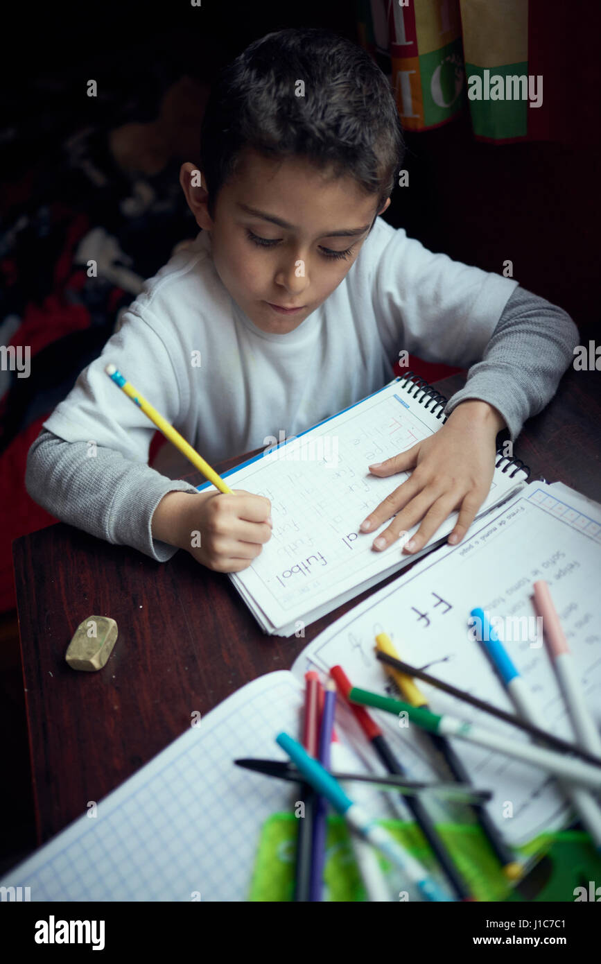 Hispanic boy practicing writing alphabet Stock Photo - Alamy