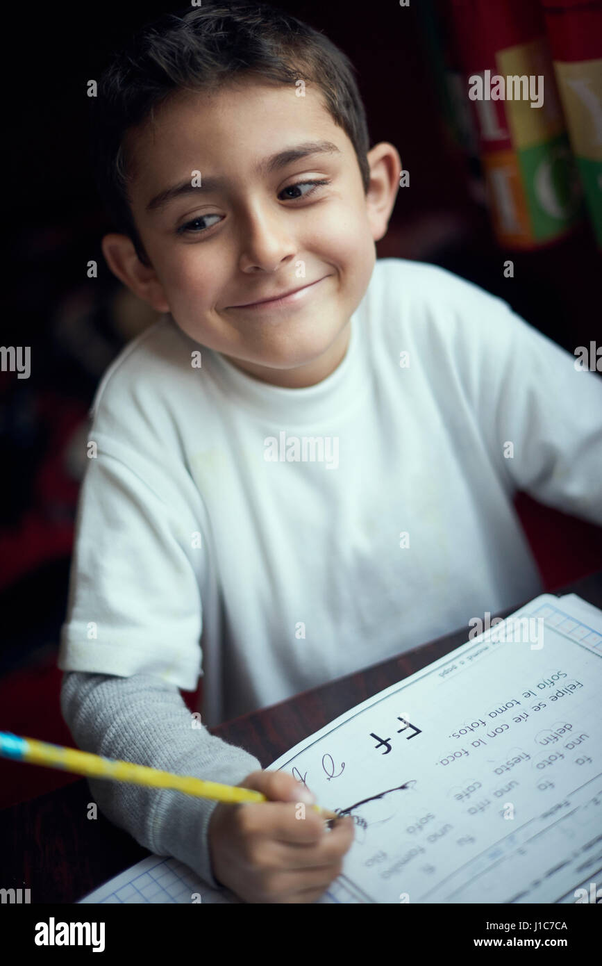 Proud Hispanic boy practicing writing alphabet Stock Photo - Alamy
