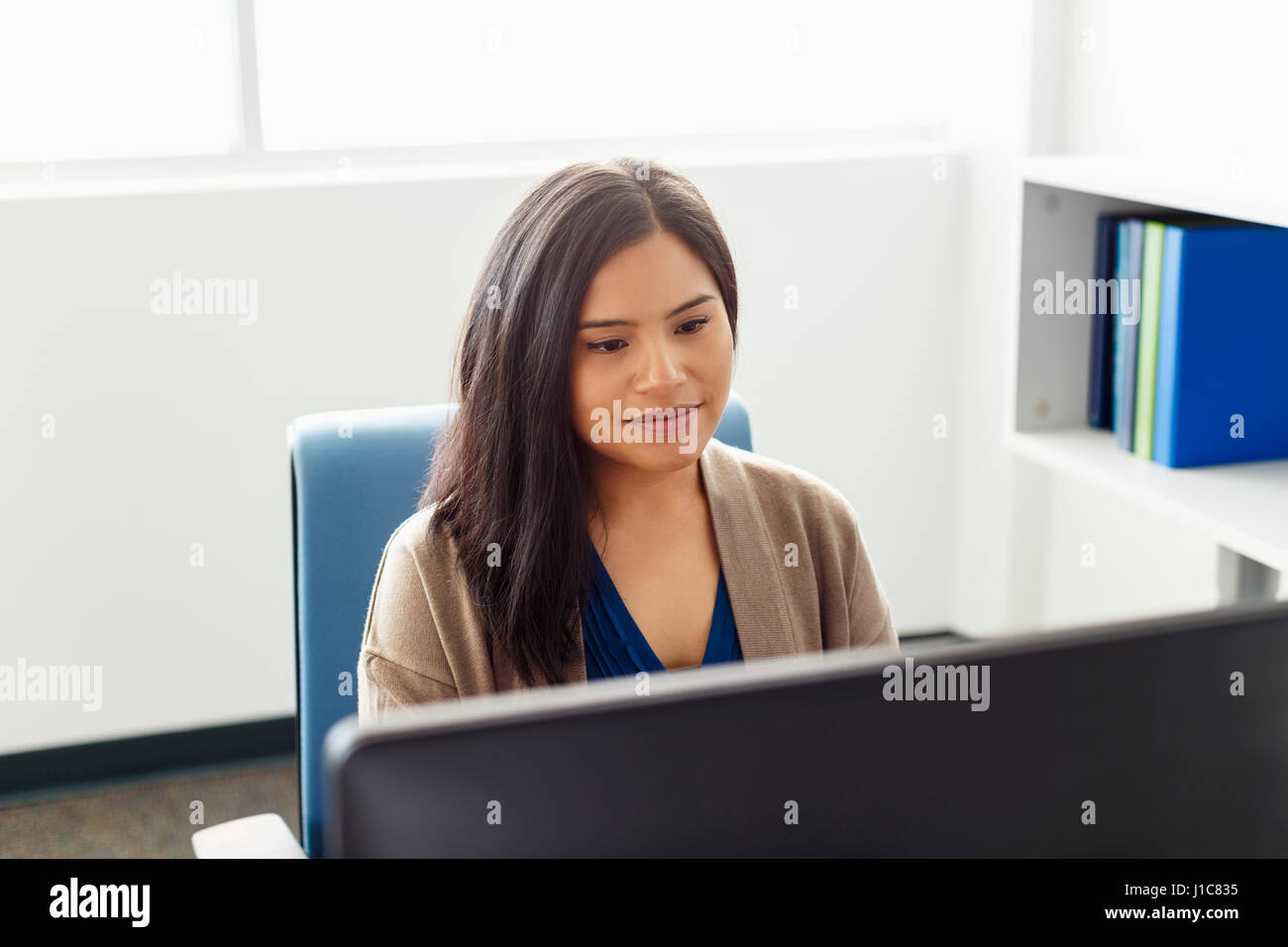 Pacific Islander woman using computer in office Stock Photo - Alamy