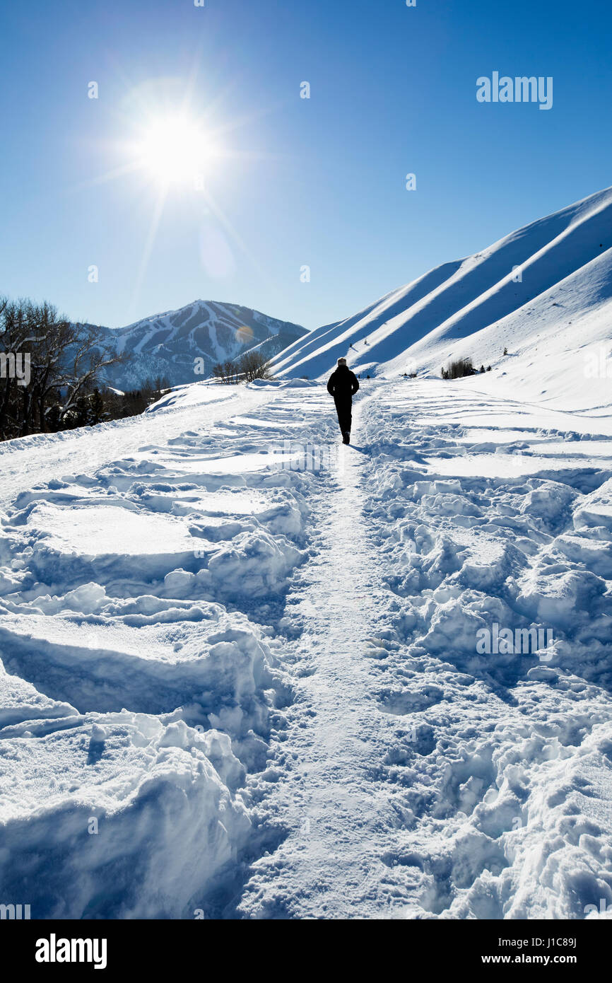 Caucasian man hiking on trail in snow on sunny mountain Stock Photo - Alamy
