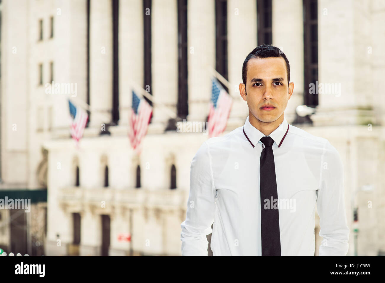 Young American Businessman wearing white shirt, black tie, standing ...