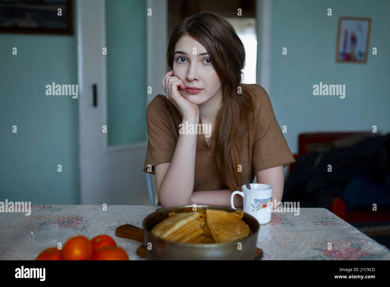 Young woman sitting dining table hi-res stock photography and images ...