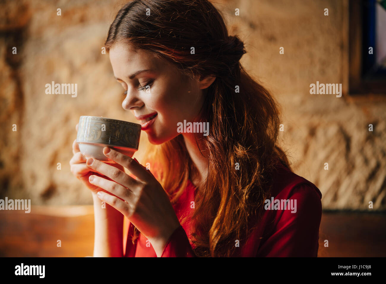 Caucasian woman sipping cup of tea Stock Photo - Alamy