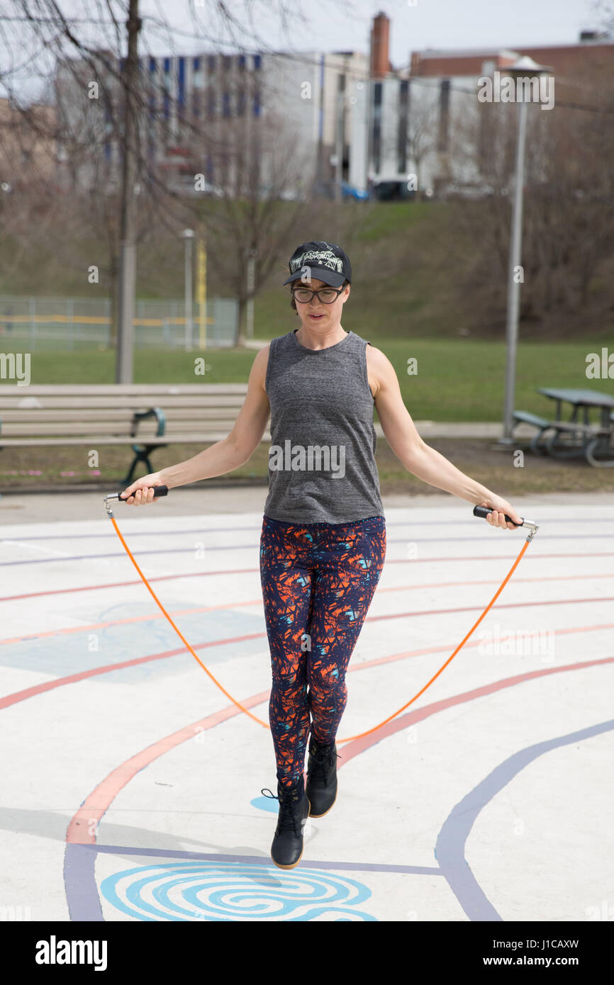 WOMAN SKIPPING ROPE IN PARK Stock Photo - Alamy