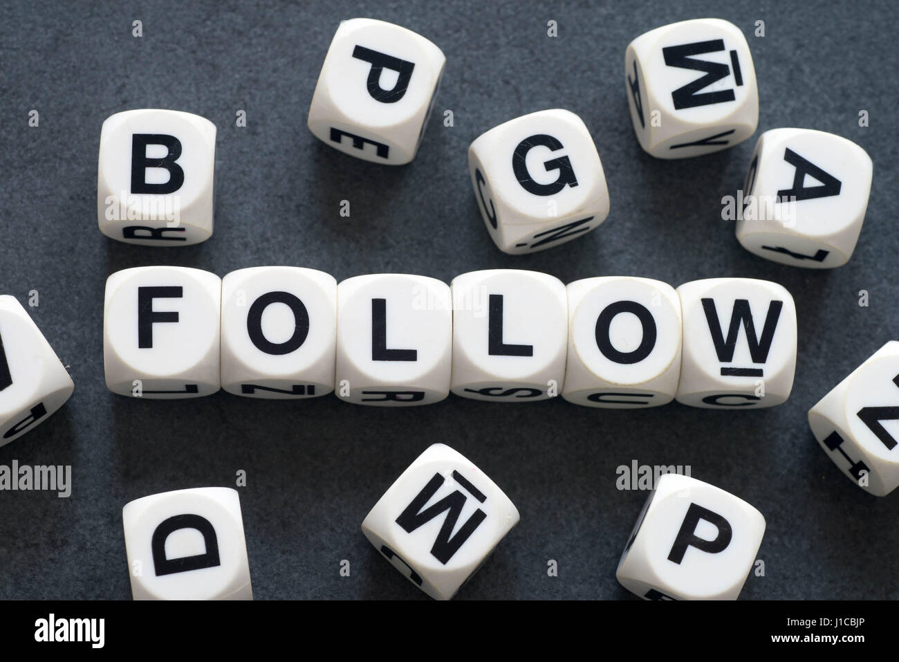 word follow on white toy cubes Stock Photo - Alamy