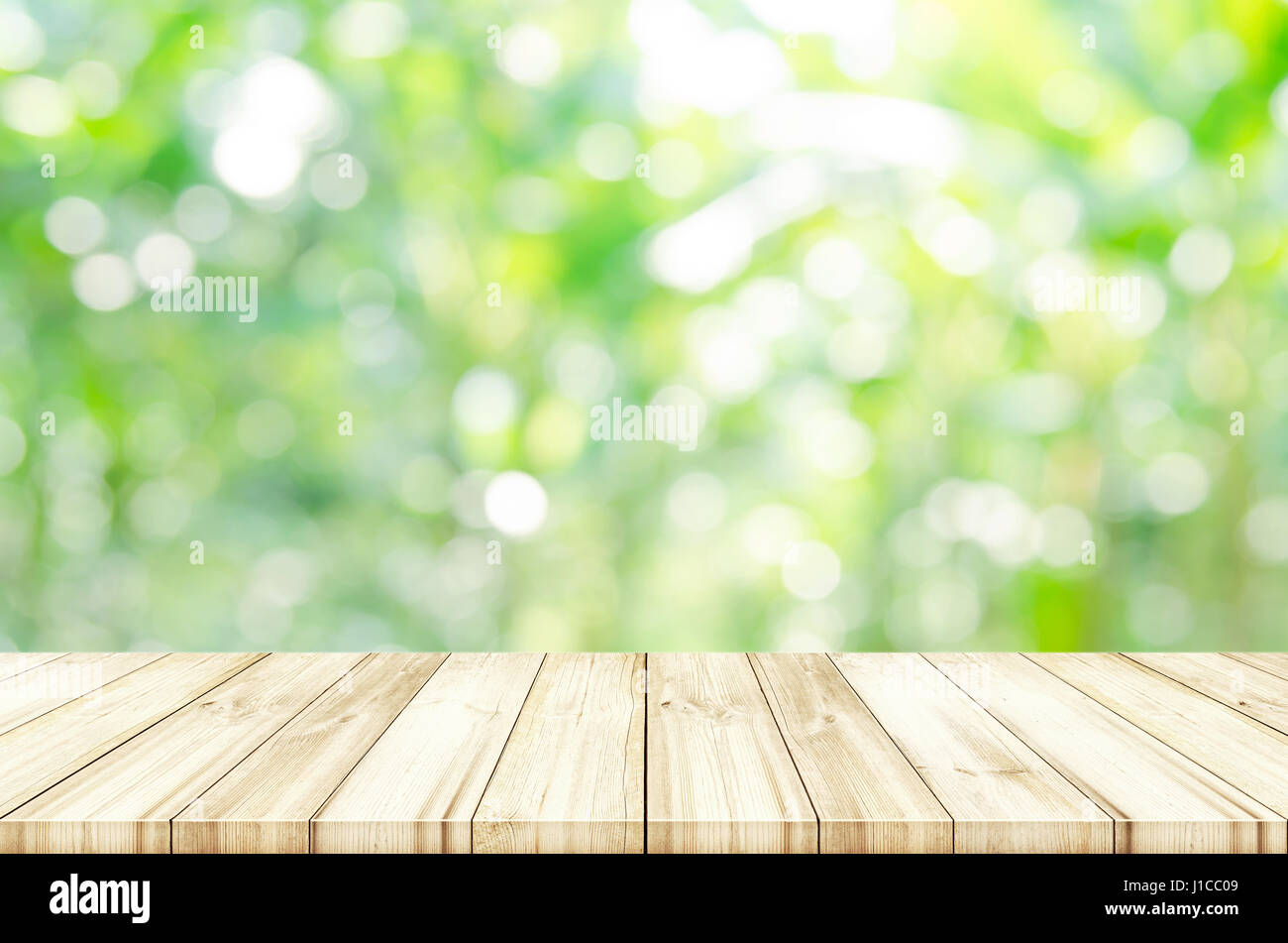 Empty wooden table top with blurred green natural abstract background ...