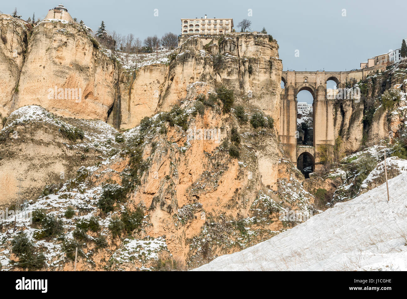 The bridge through the gorge between two hills in winter. Ronda, Malaga ...