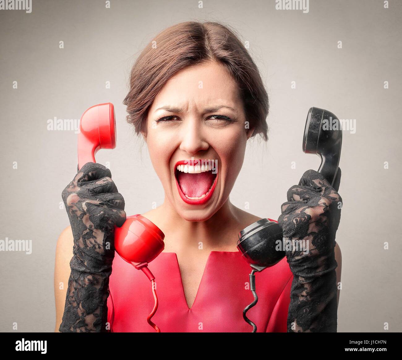 Frustrated woman trying to handle with more phone conversation Stock ...