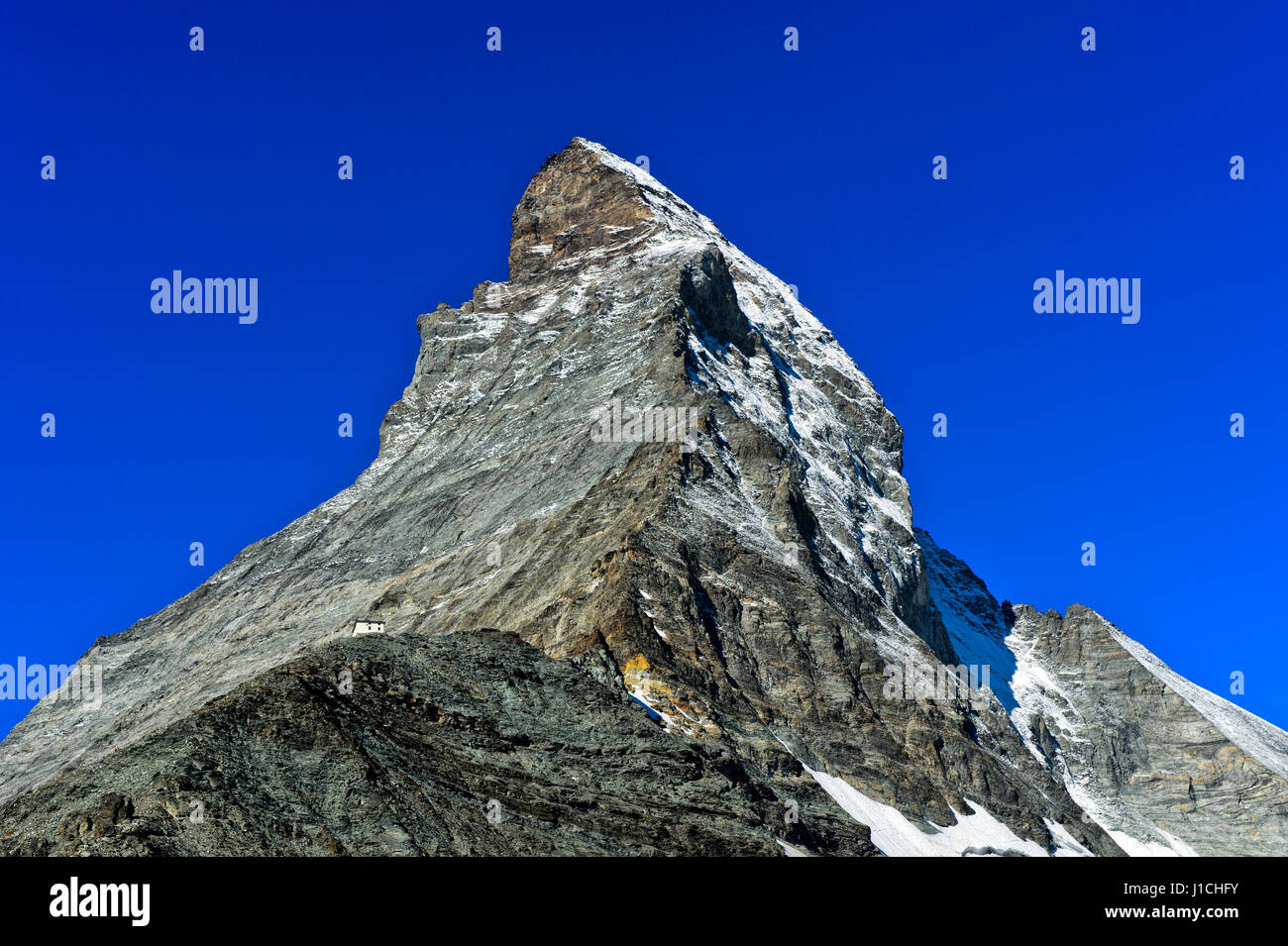 Mountain hut Hoernlihuette and Hoernli ridge at the Matterhorn peak ...