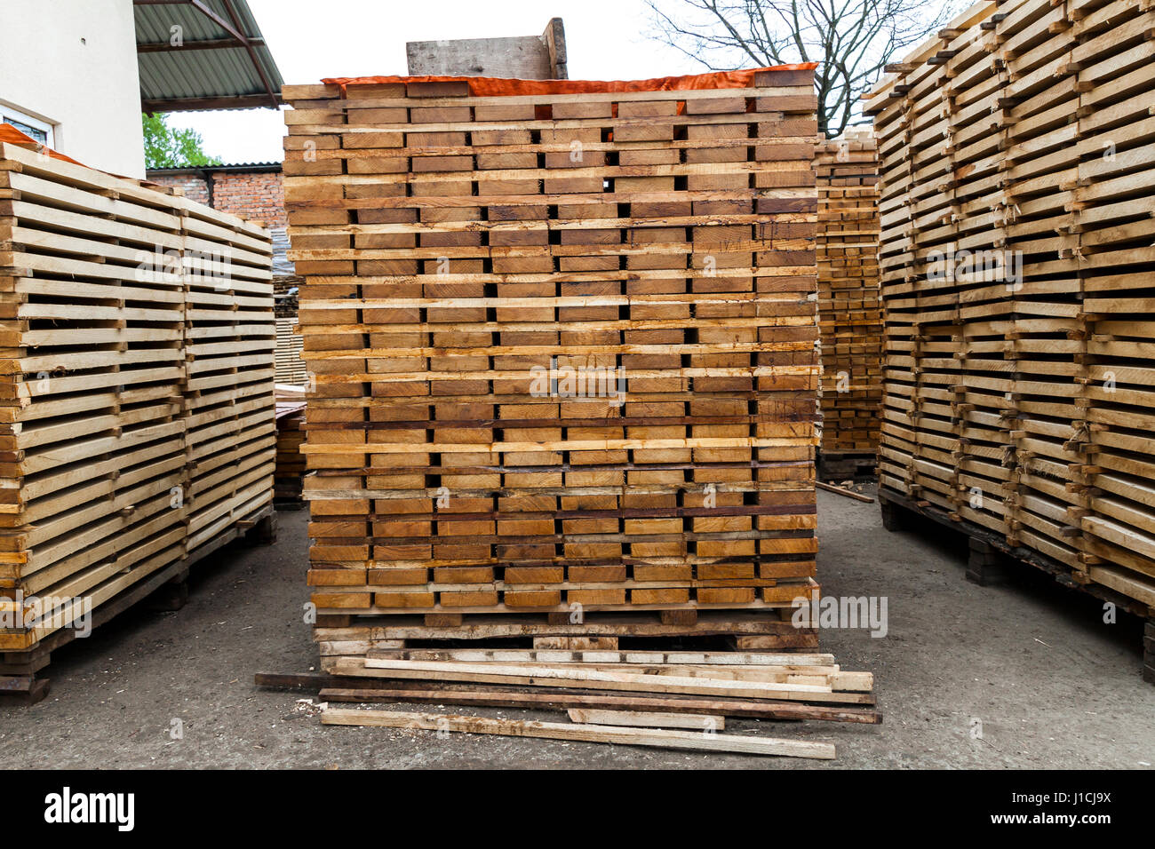 Stack of new wooden boards and studs at the lumber yard. Wooden plates ...