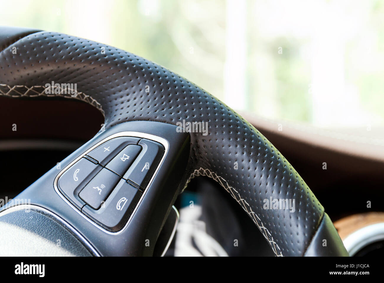 Element of steering wheel with control buttons in modern car interior ...