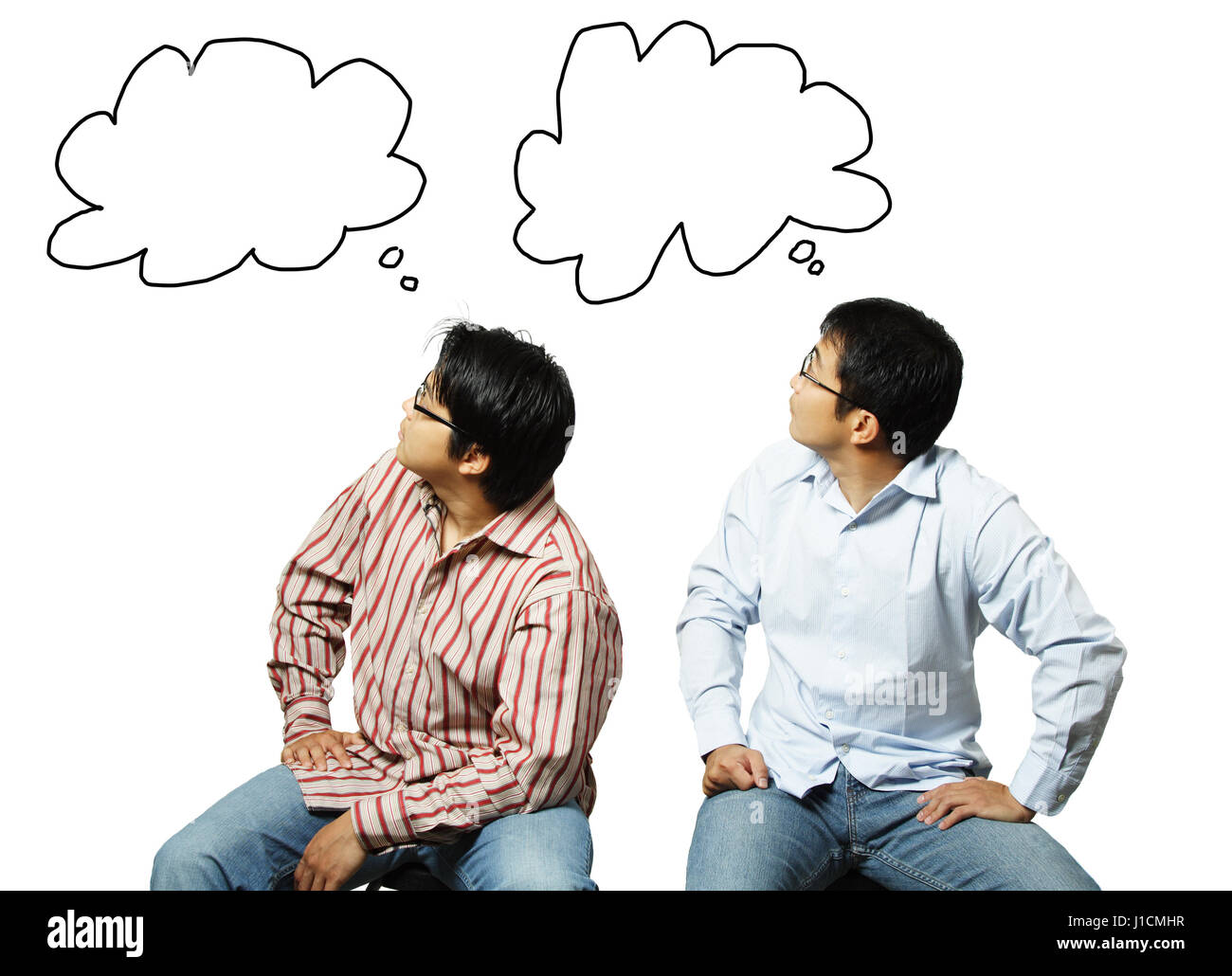 A conceptual shot of two businessmen looking at their own thoughts ...