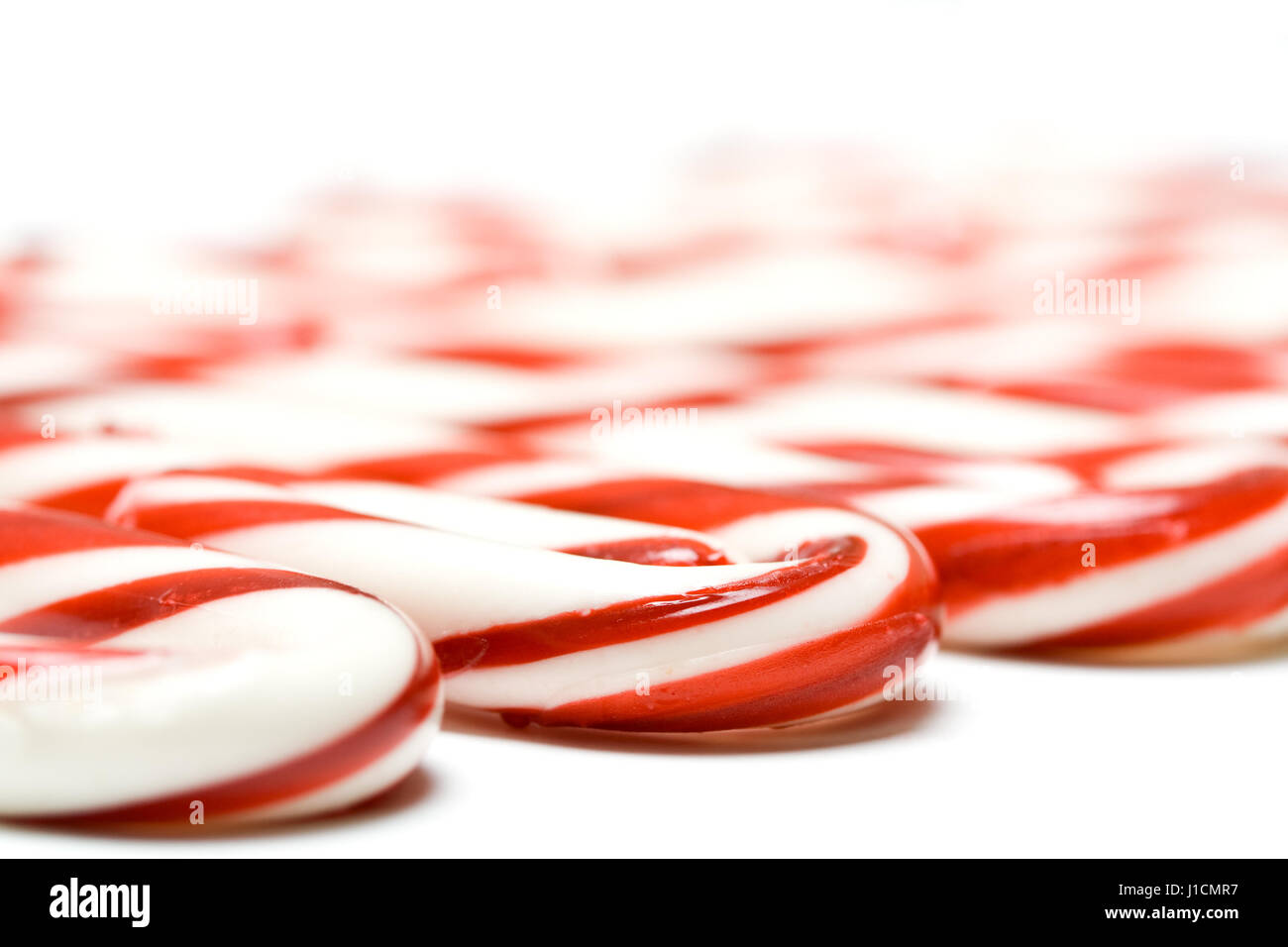 A shot of christmas candy cane in a row Stock Photo - Alamy