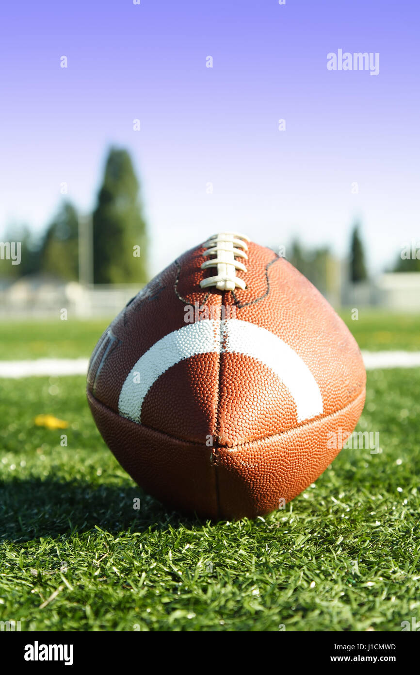 An american football on a football field Stock Photo - Alamy