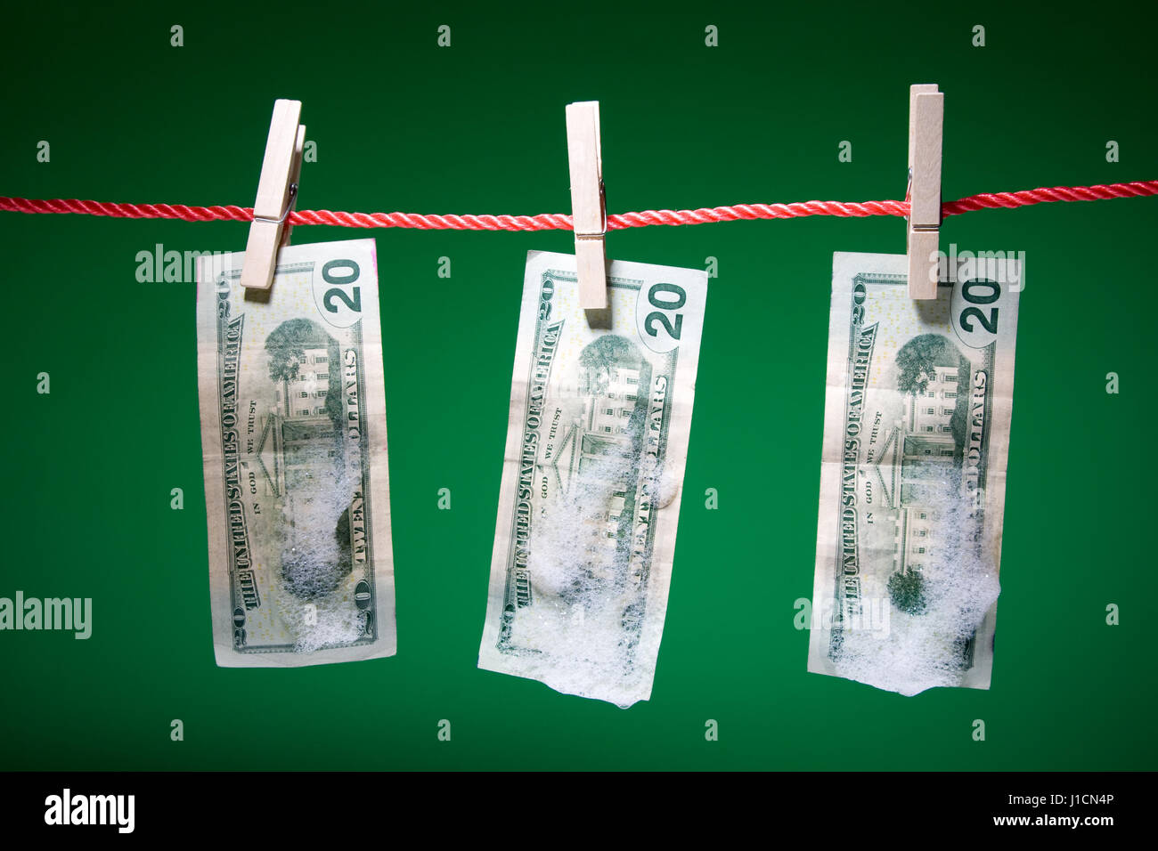 A shot of dollar bills washed with soap hanging on clothesline Stock ...