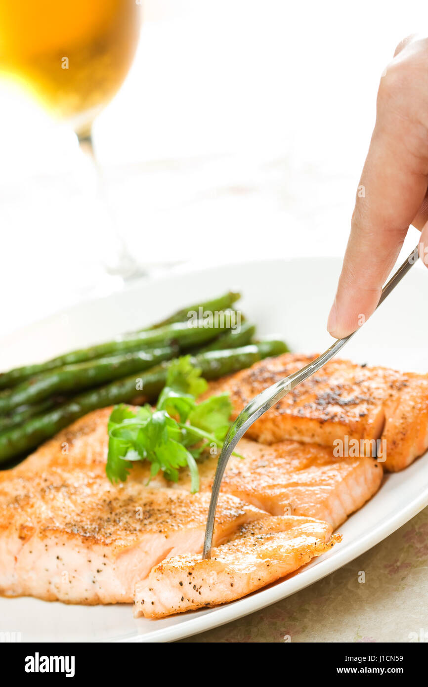 A shot of a baked salmon with string beans Stock Photo - Alamy