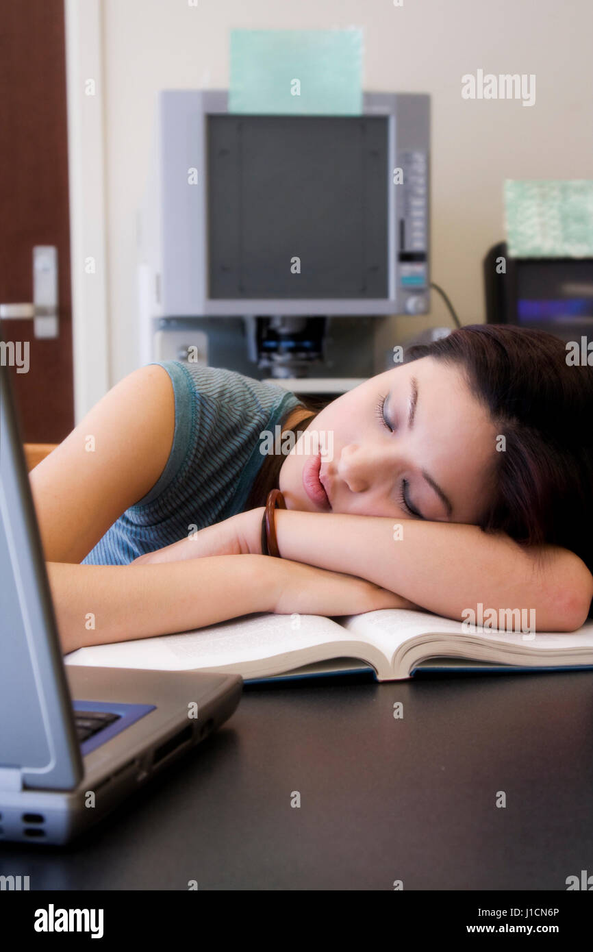 A tired college student taking a nap at the library Stock Photo - Alamy